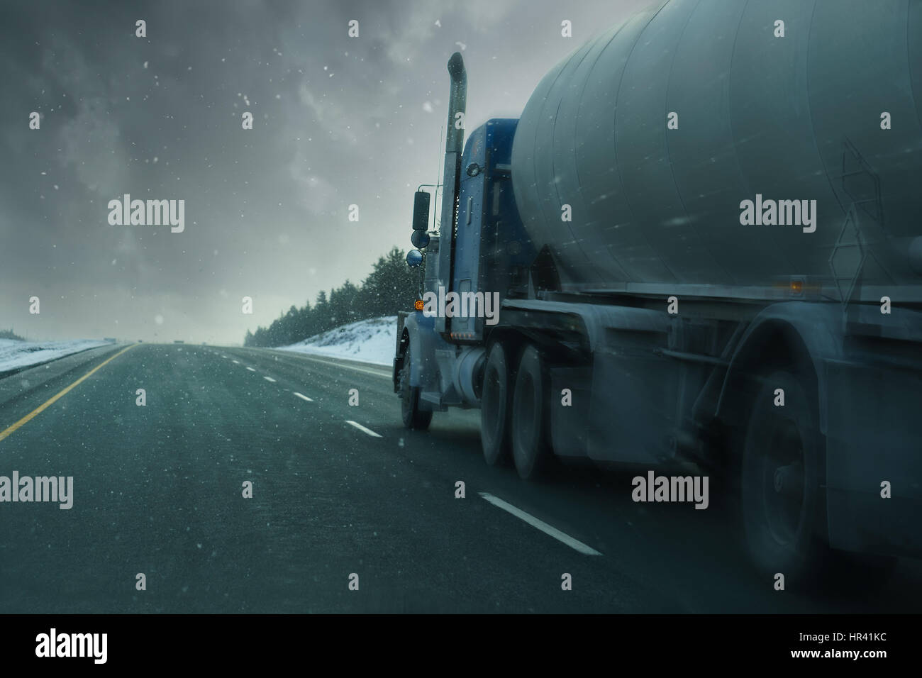 Tanker truck moving fast up a hill while the snow is falling Stock ...