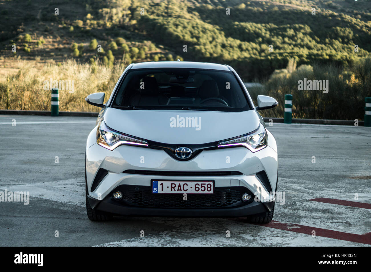 Front on of a white Toyota C-HR CHR on a helipad, hills and scenery in ...