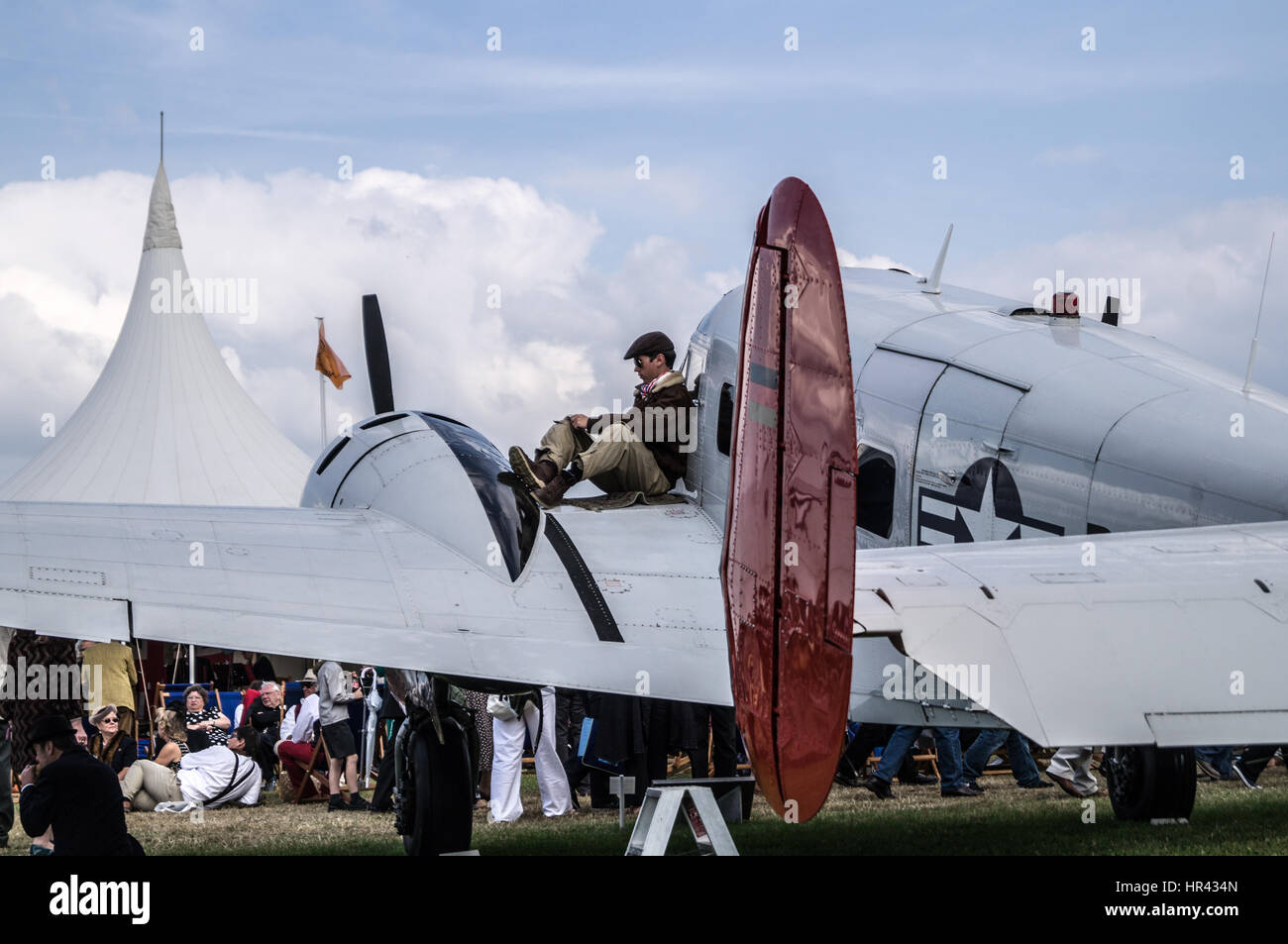 Old fashioned dressed pilot sits on wing of american plane Stock Photo ...