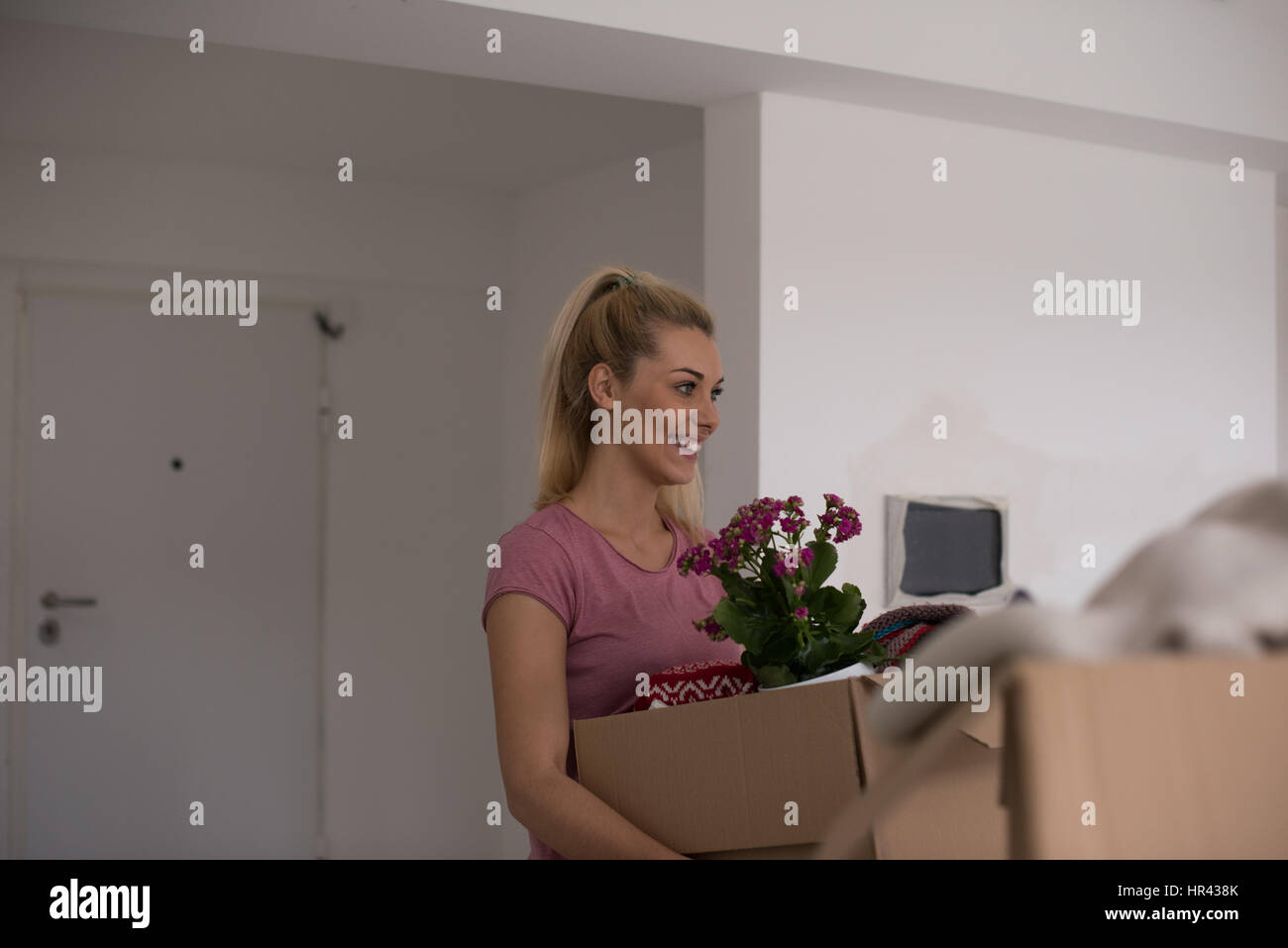 Beautiful girl moving in the new apartment Stock Photo - Alamy