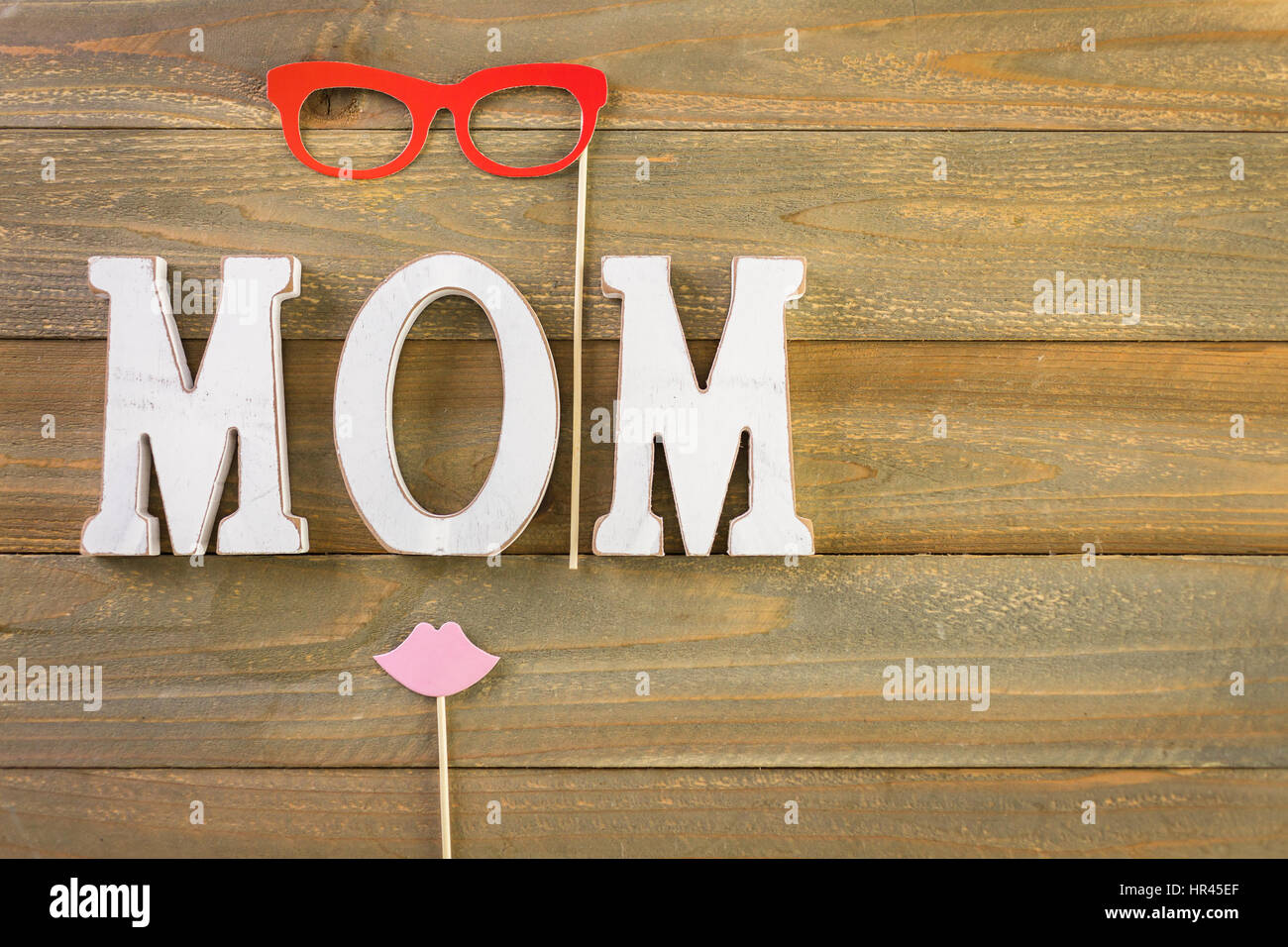White letters MOM on a painted wood background Stock Photo - Alamy