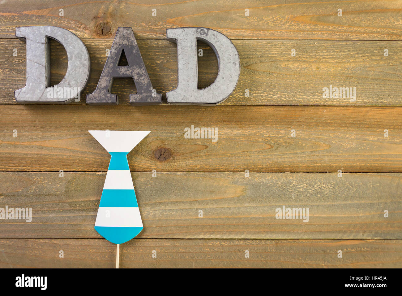 Metal letters DAD on a painted wood background Stock Photo - Alamy