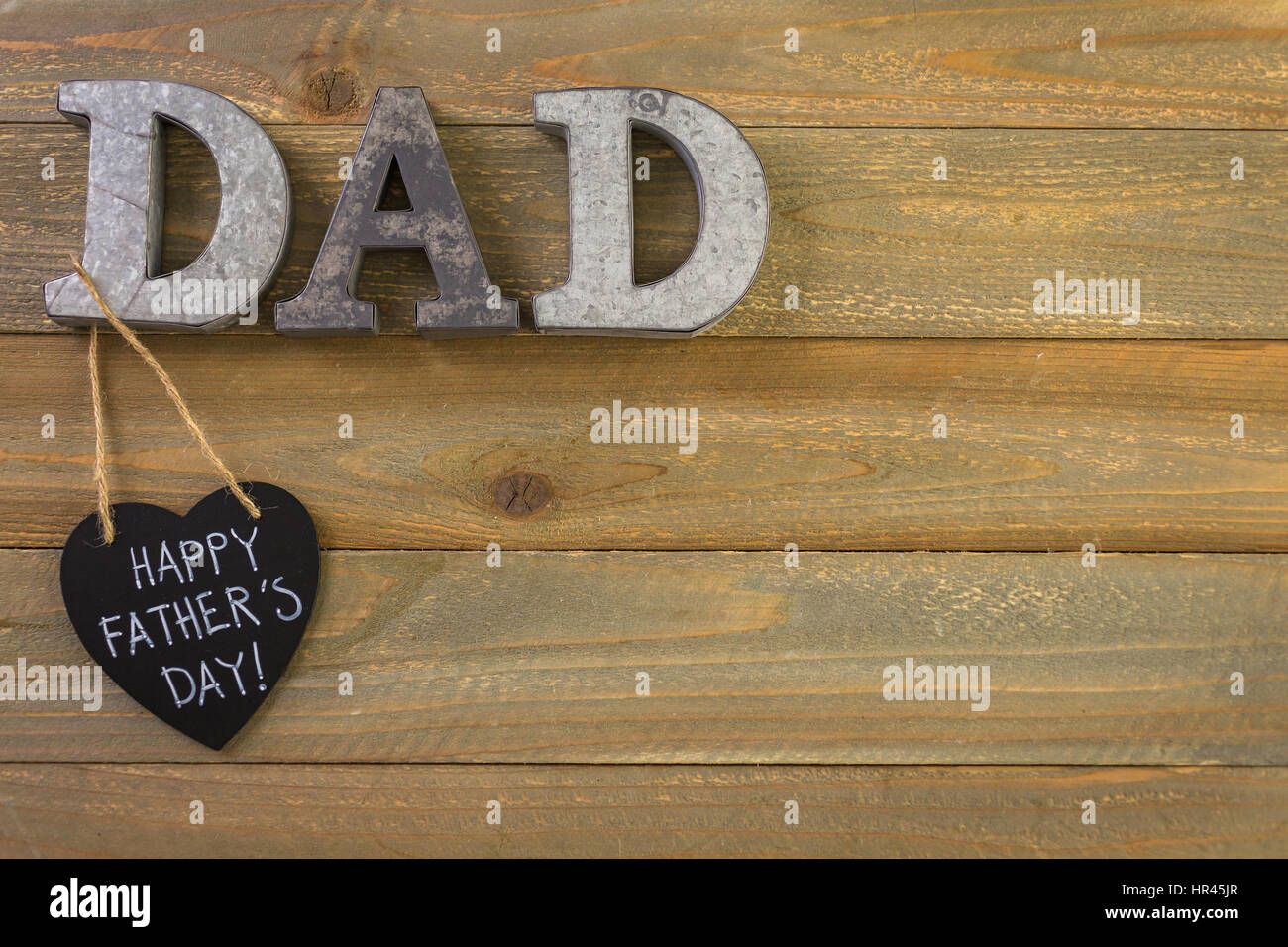 Metal letters DAD on a painted wood background Stock Photo - Alamy