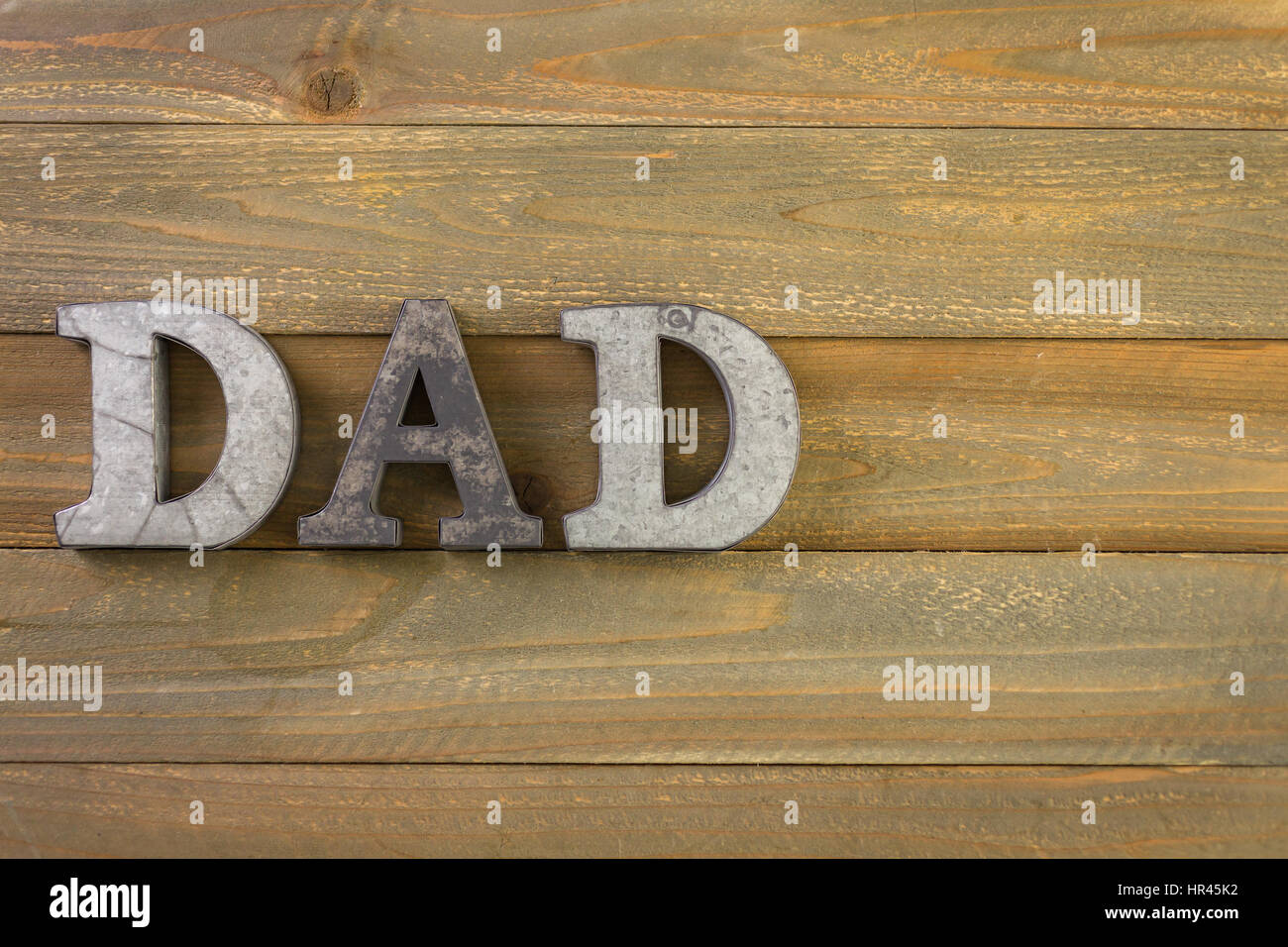 Metal letters DAD on a painted wood background Stock Photo - Alamy