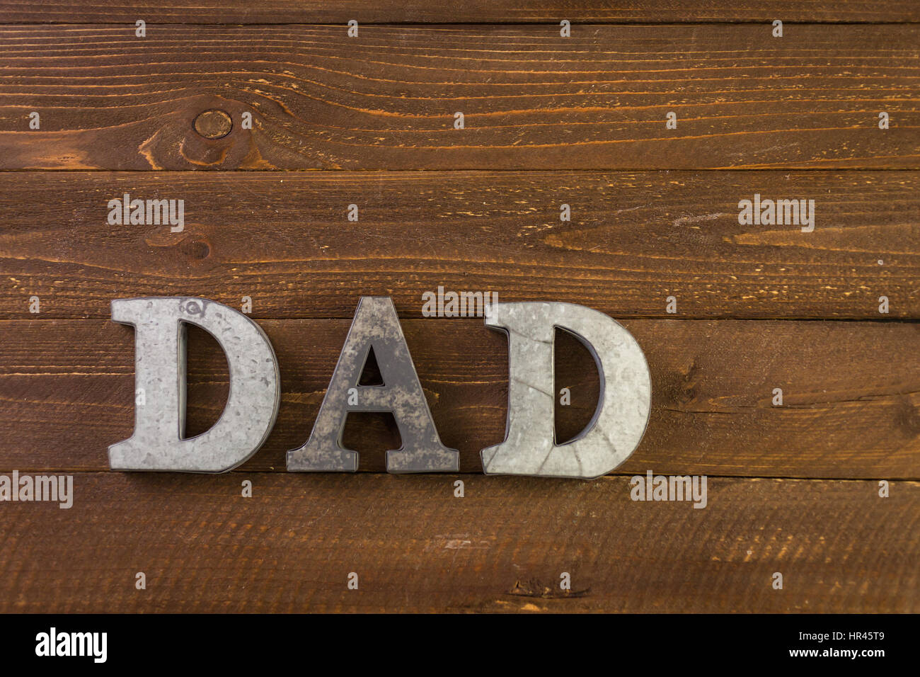 Metal letters DAD on a painted wood background Stock Photo - Alamy