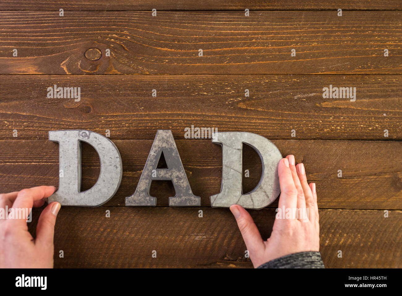 Metal letters DAD on a painted wood background Stock Photo - Alamy