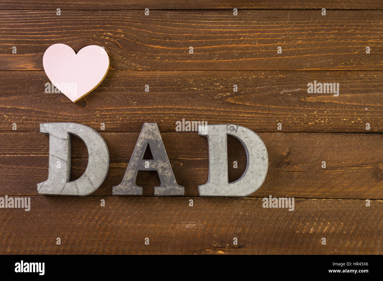 Metal letters DAD on a painted wood background Stock Photo - Alamy
