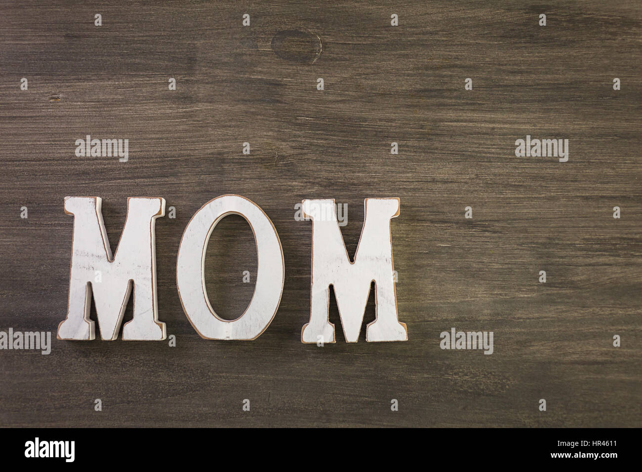 White letters MOM on a painted wood background Stock Photo - Alamy