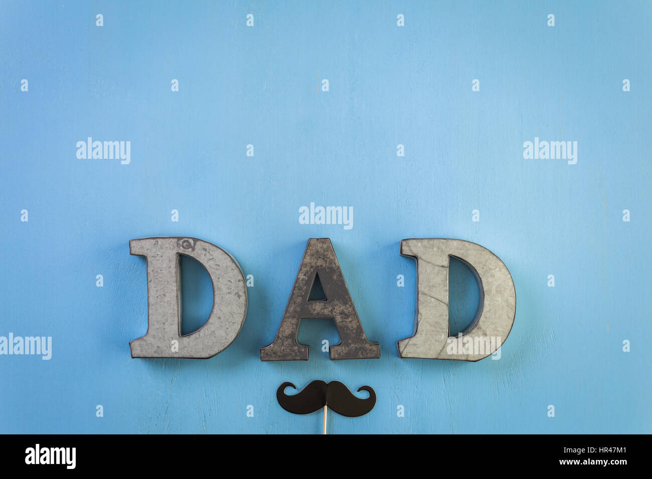 Metal letters DAD on a painted wood background Stock Photo - Alamy