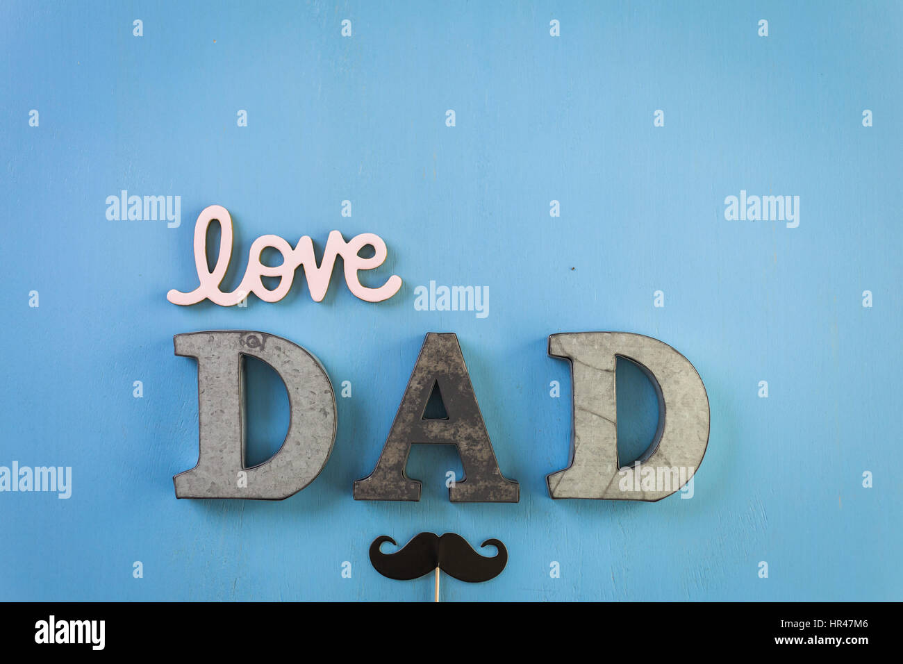 Metal letters DAD on a painted wood background Stock Photo - Alamy