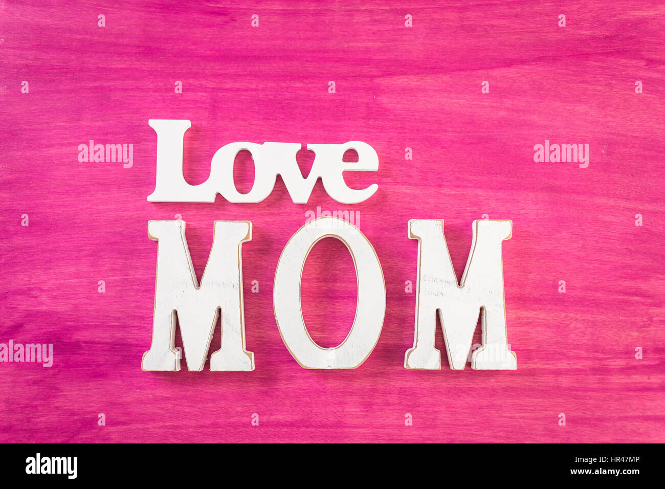 White letters MOM on a painted wood background Stock Photo - Alamy