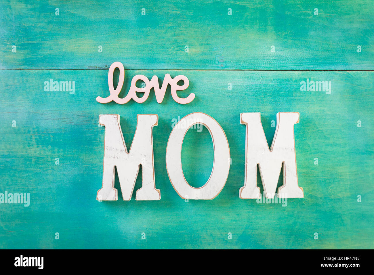 White letters MOM on a painted wood background Stock Photo - Alamy