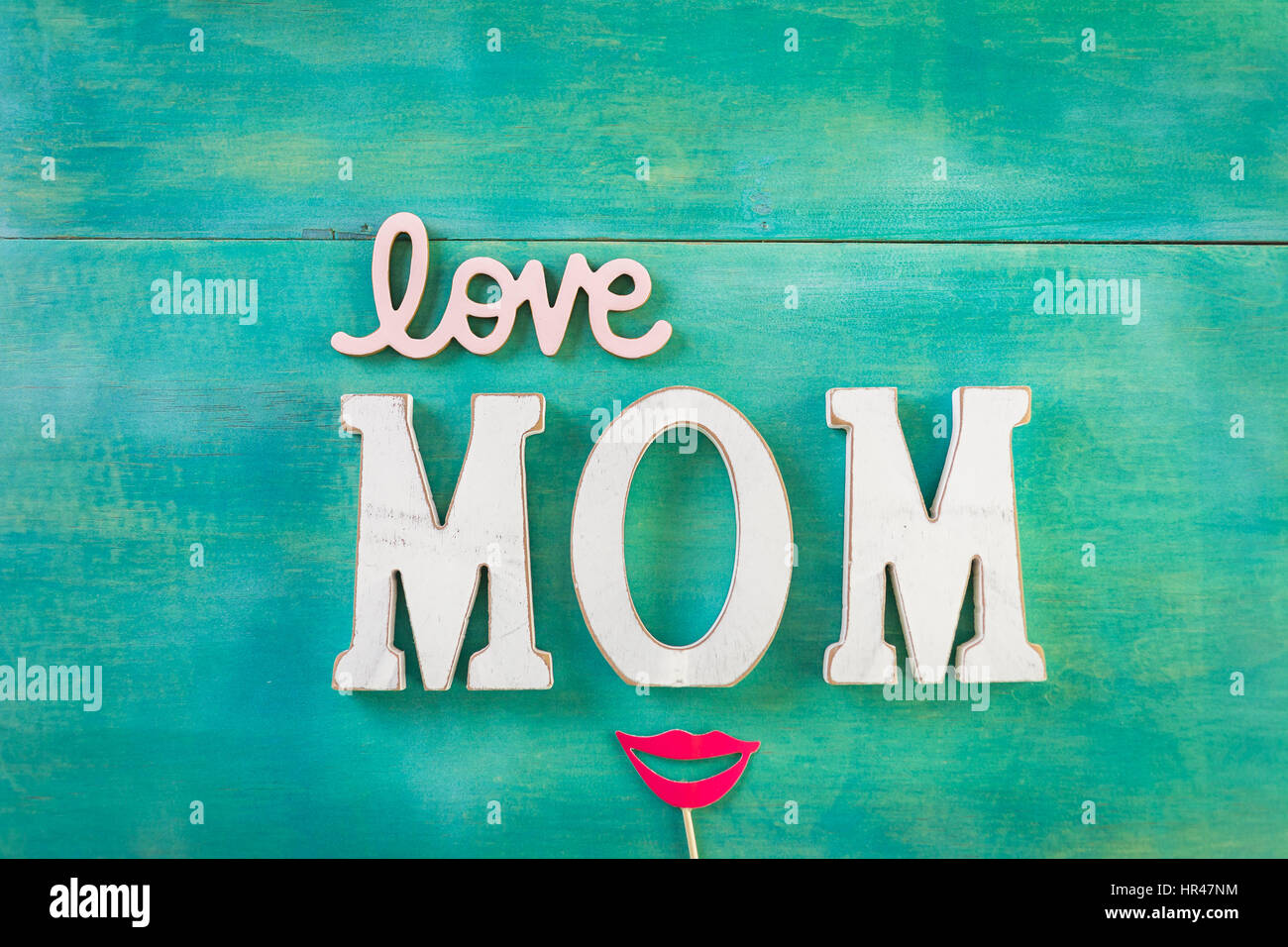 White letters MOM on a painted wood background Stock Photo - Alamy