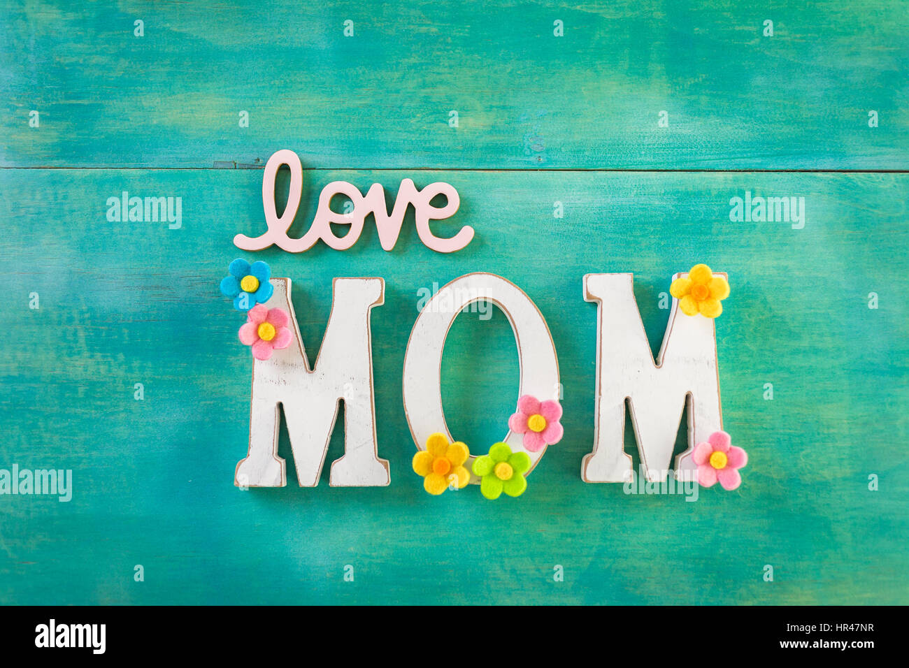 White letters MOM on a painted wood background Stock Photo - Alamy