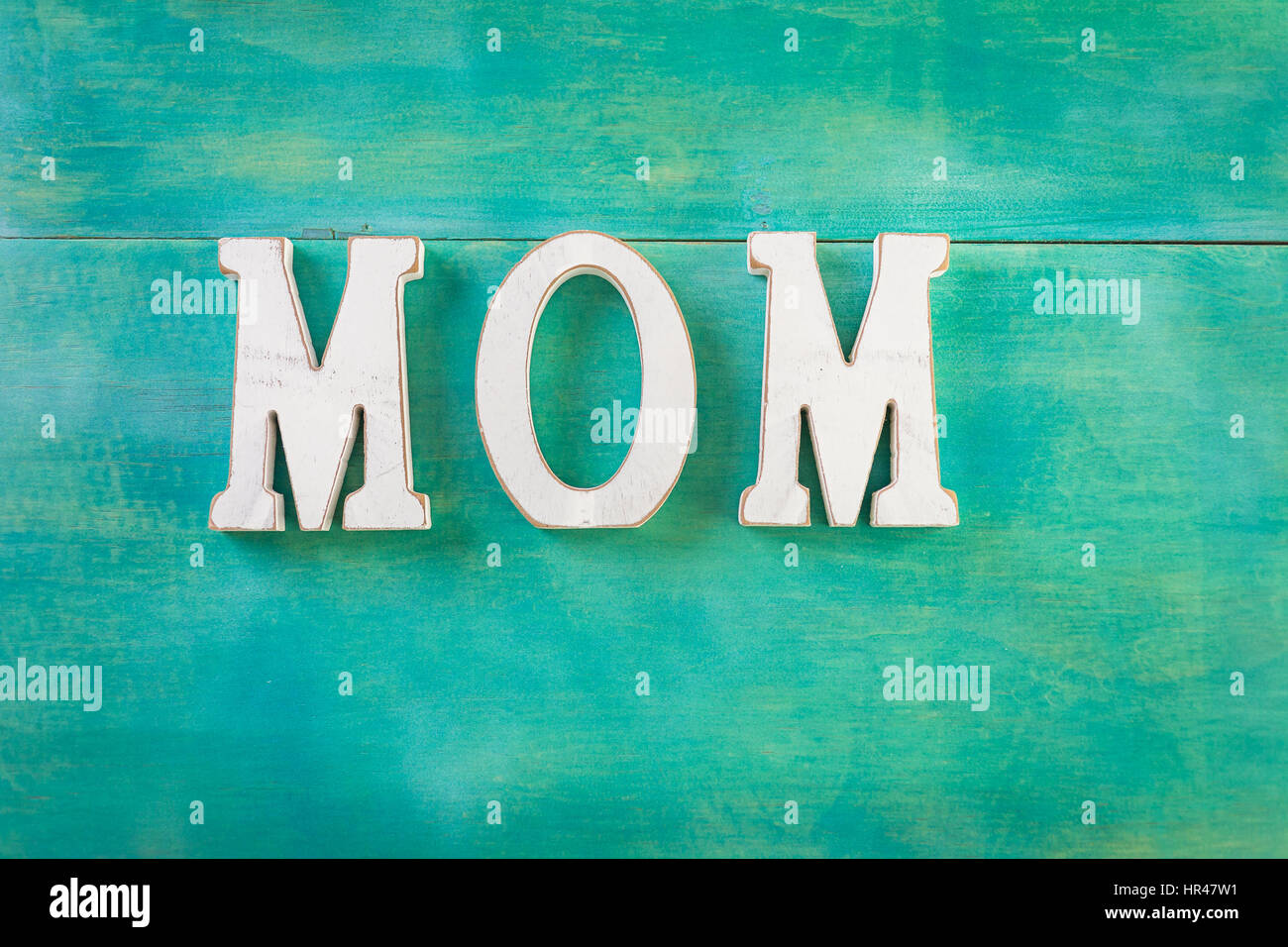 White letters MOM on a painted wood background Stock Photo - Alamy