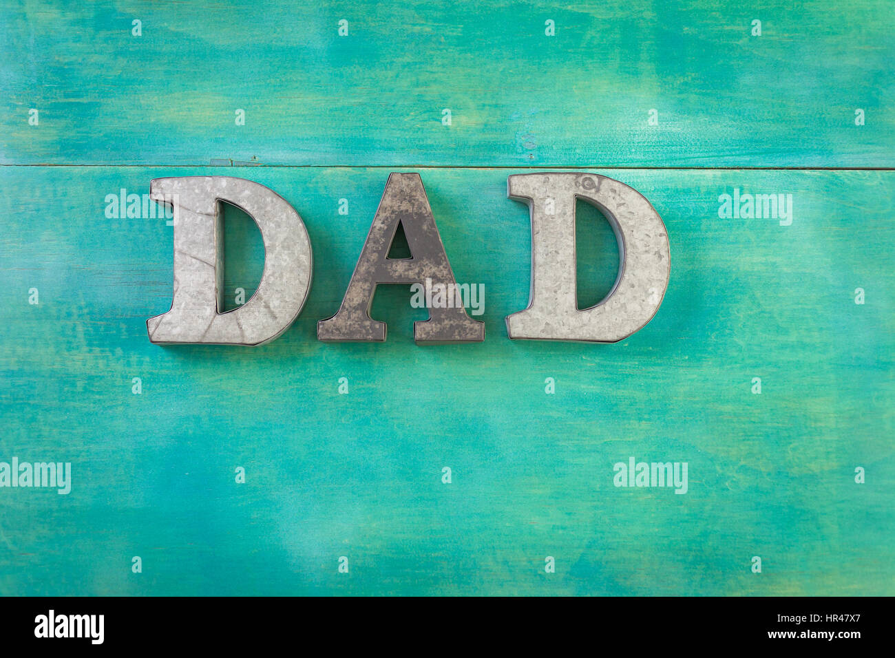 Metal letters DAD on a painted wood background Stock Photo - Alamy