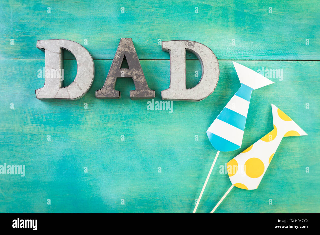 Metal letters DAD on a painted wood background Stock Photo - Alamy