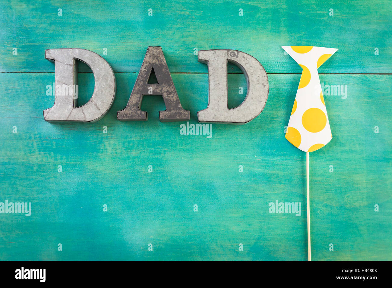 Metal letters DAD on a painted wood background Stock Photo - Alamy