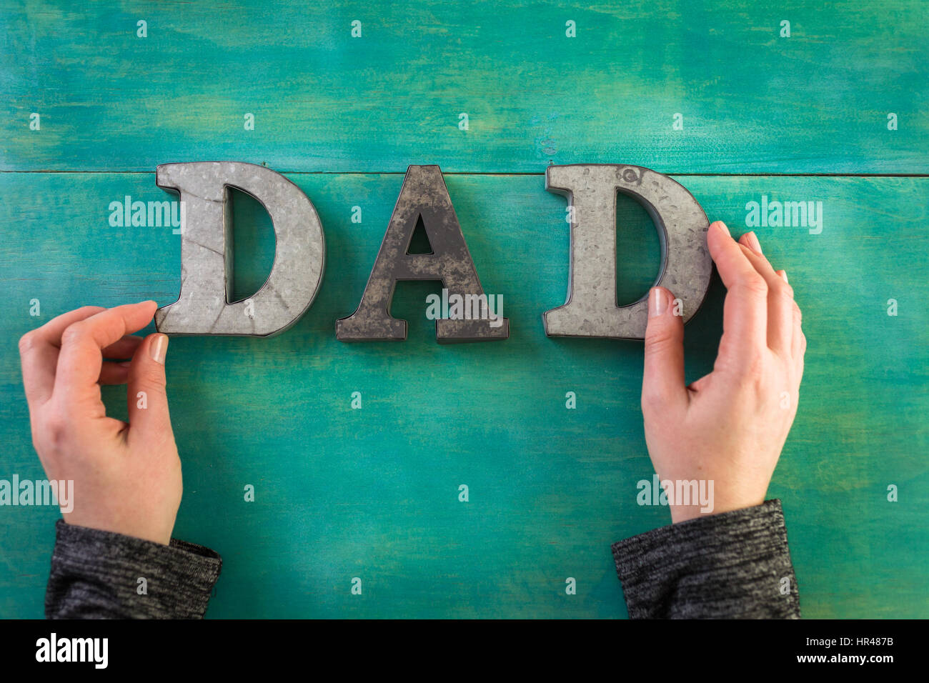 Metal letters DAD on a painted wood background Stock Photo - Alamy