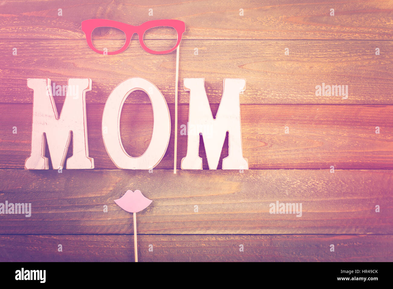 White letters MOM on a painted wood background Stock Photo - Alamy