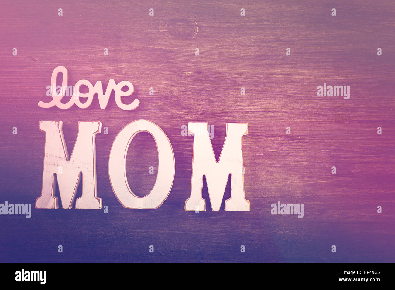 White letters MOM on a painted wood background Stock Photo - Alamy