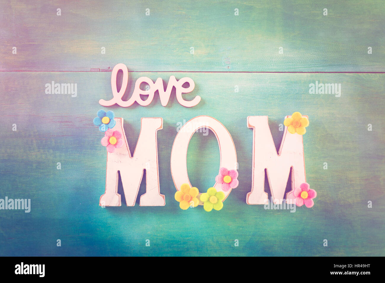 White letters MOM on a painted wood background Stock Photo - Alamy