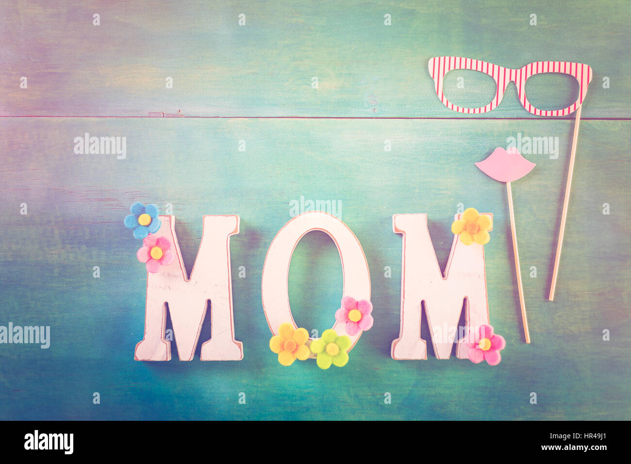 White letters MOM on a painted wood background Stock Photo - Alamy