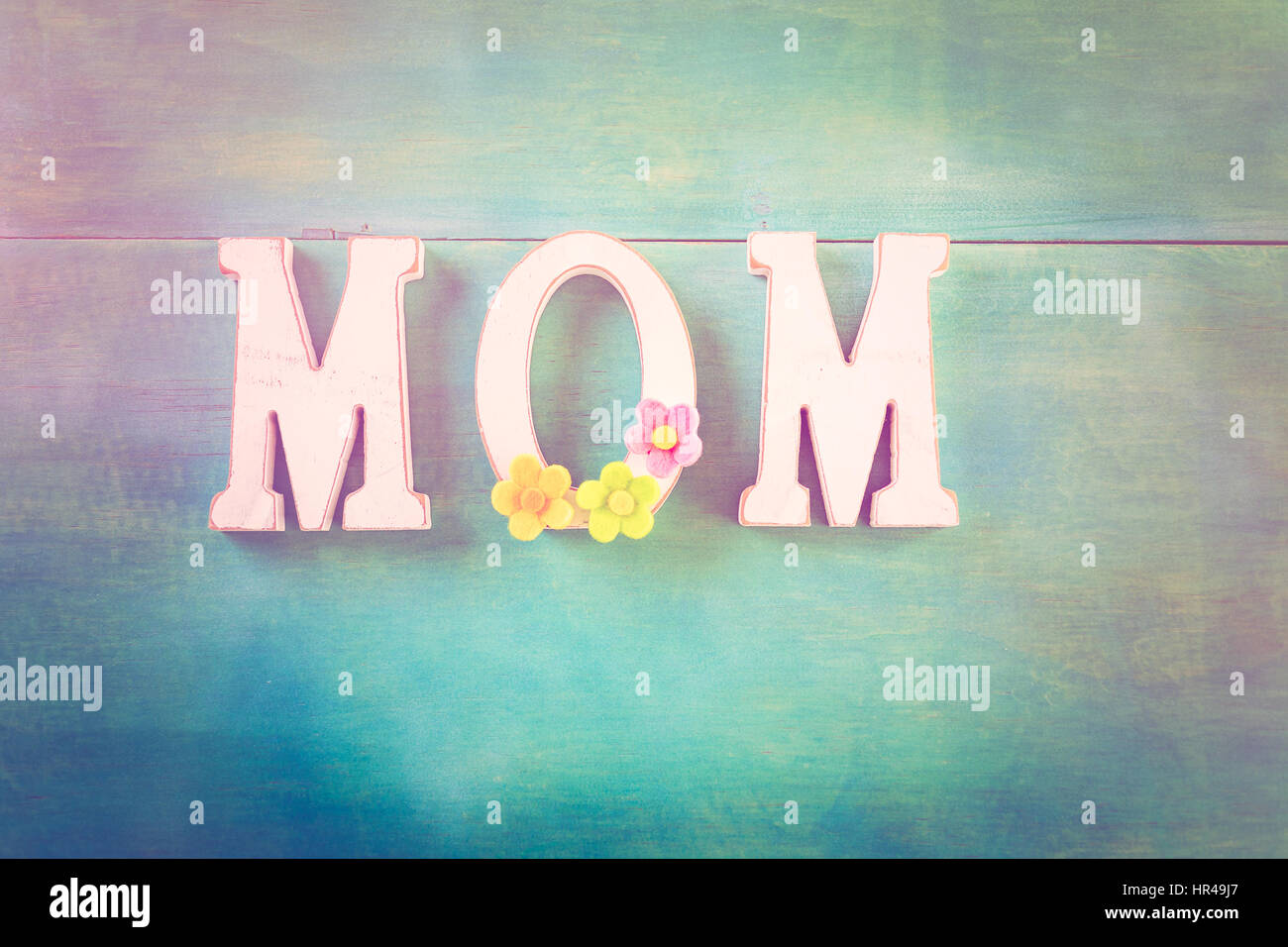 White letters MOM on a painted wood background Stock Photo - Alamy