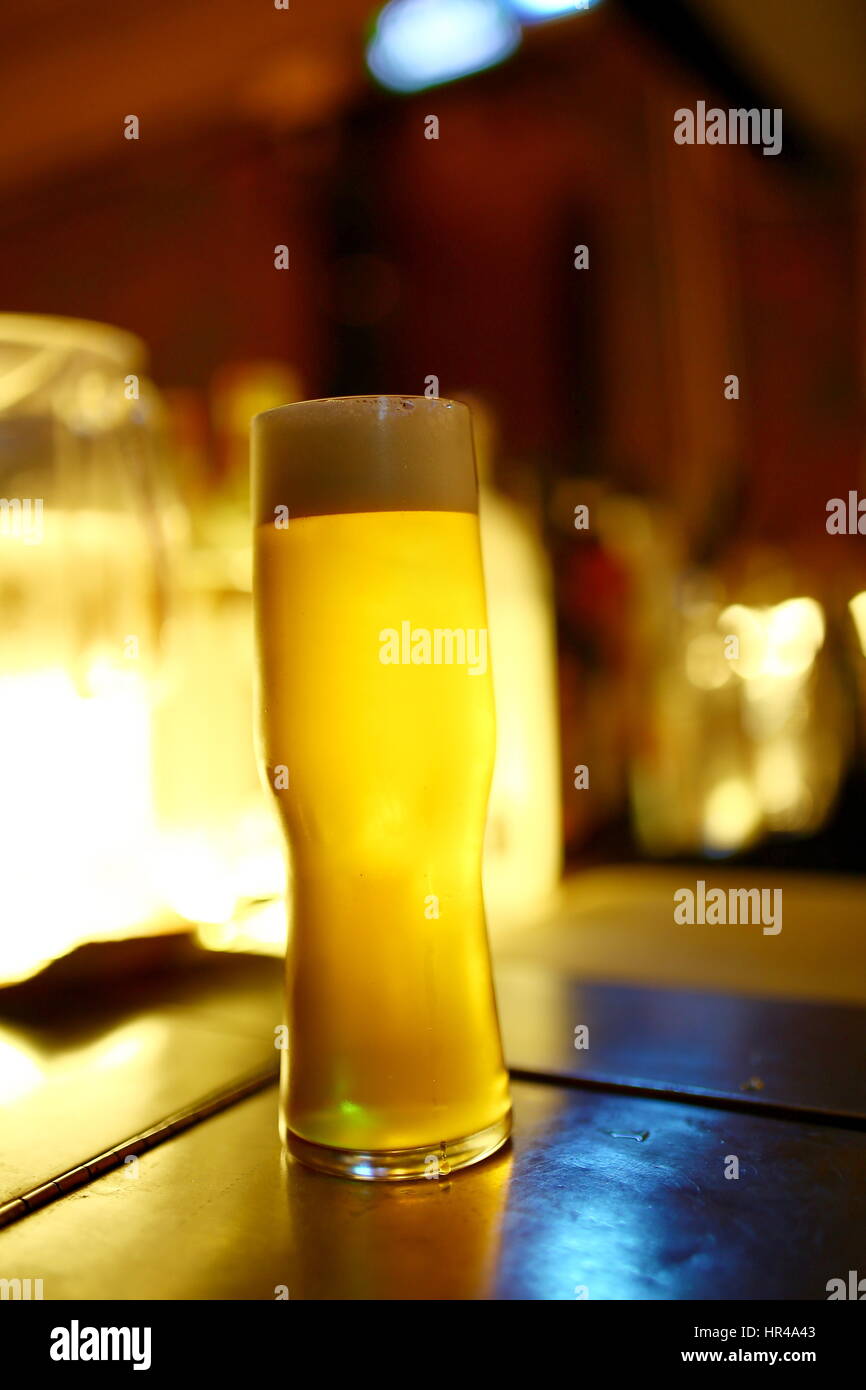 A glass of beer on the bar Stock Photo - Alamy