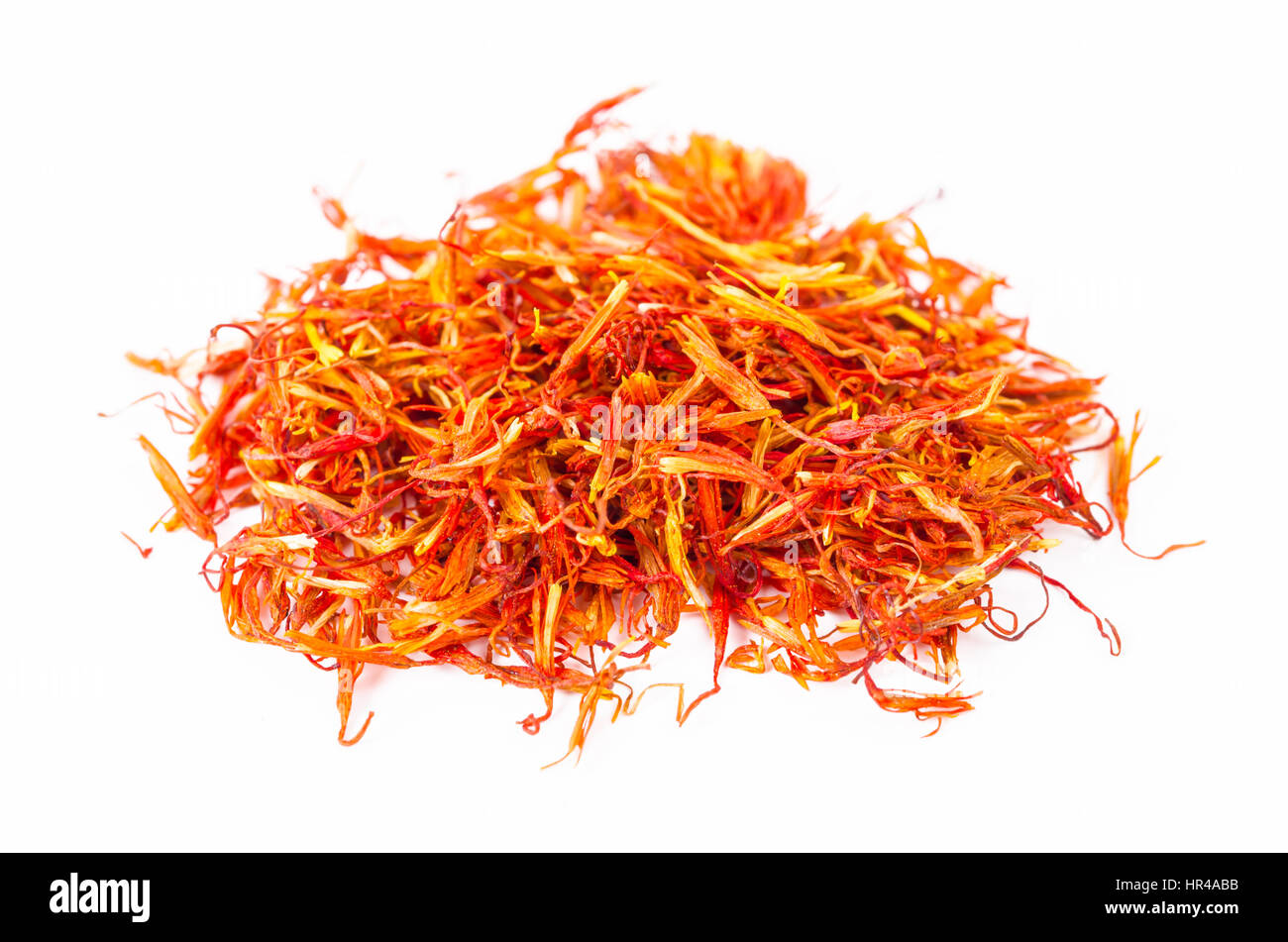 Safflower petals heap on white background Stock Photo - Alamy