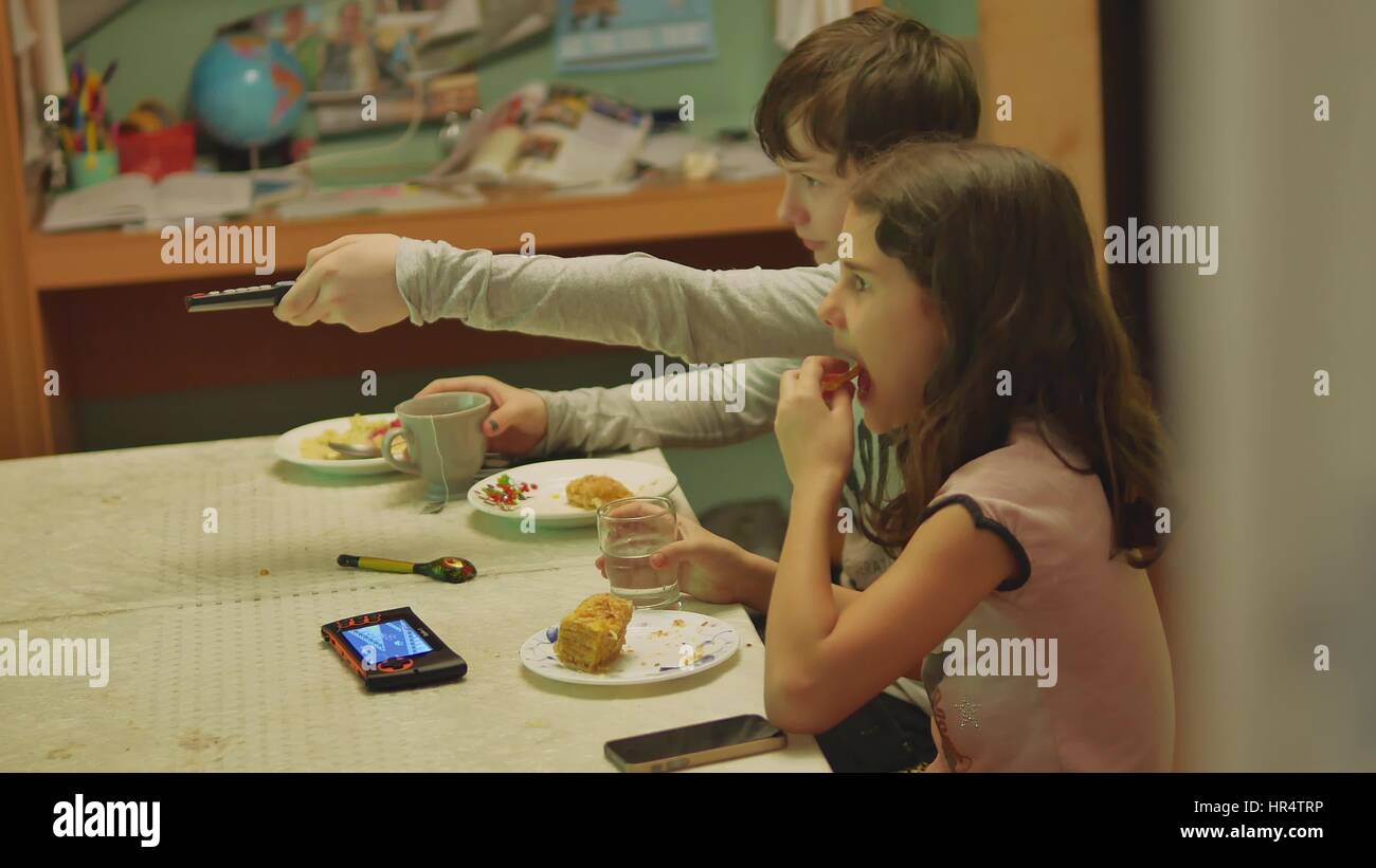 A boy child kid watching tv with remote control hi-res stock ...