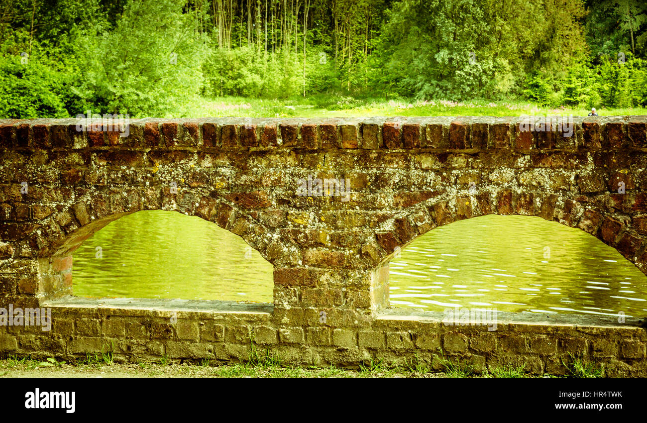 Pretty stone bridge over a calm river, Belgium Stock Photo - Alamy