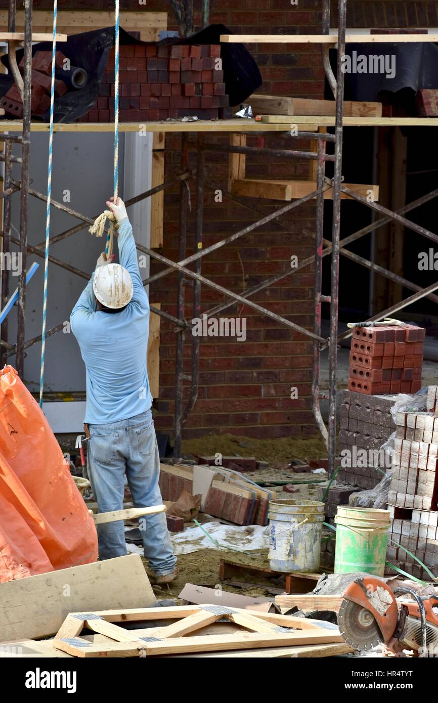 Construction worker building a home Stock Photo - Alamy