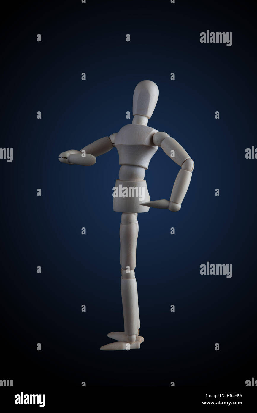 Wooden figurine flexing muscles in bodybuilder pose on dark background ...