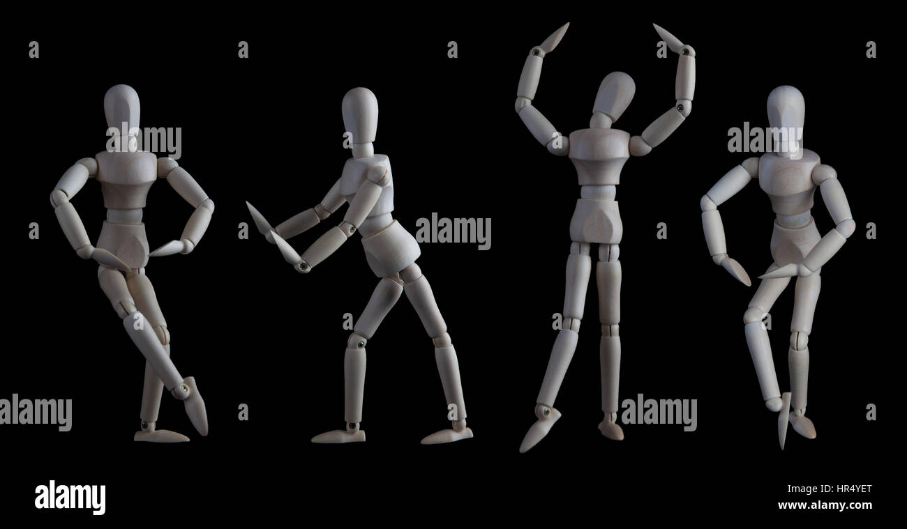 Set of wooden figurines in elegant dance move poses isolated on black ...