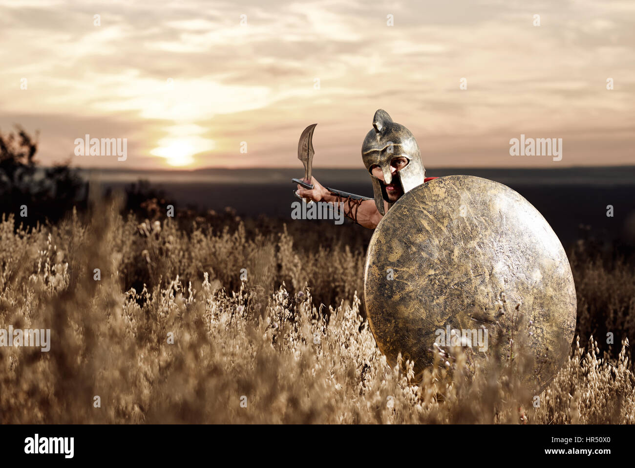 Sepia toned shot of a Greek warrior attacking with a sword on the ...