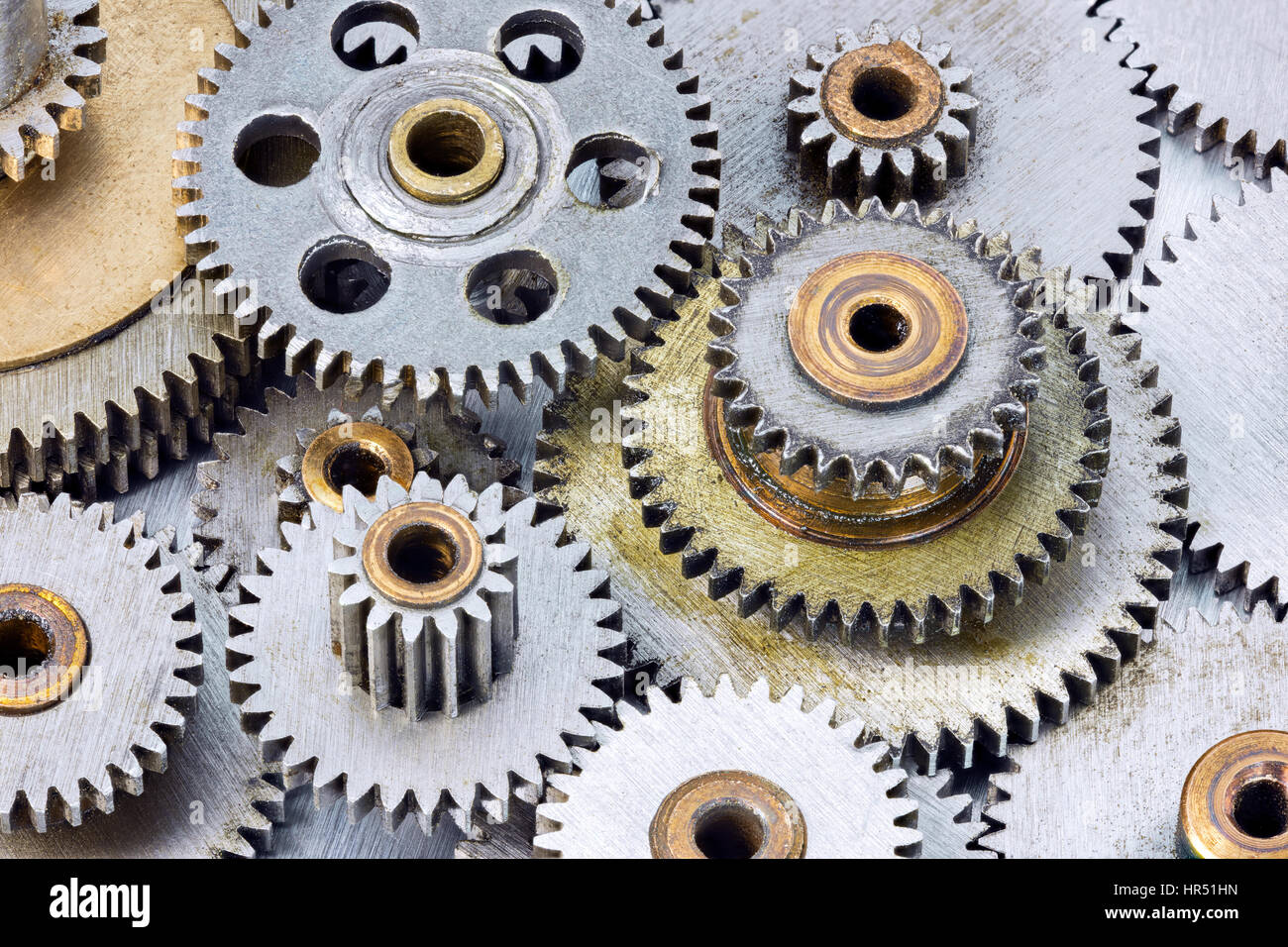 set of various metal grey cogwheels on industrial background closeup ...