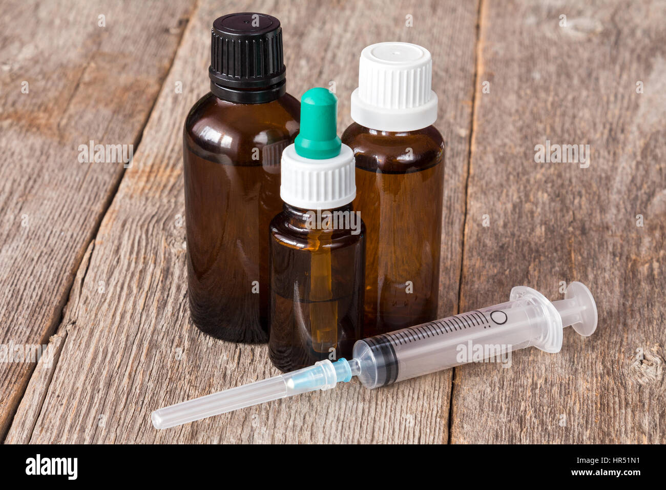 Medical syringe and bottles kits on wooden background Stock Photo - Alamy