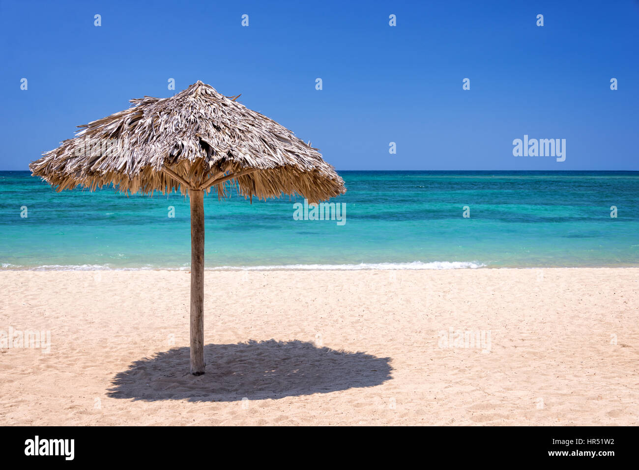 Caribbean tropical beach straw umbrella hi-res stock photography and ...