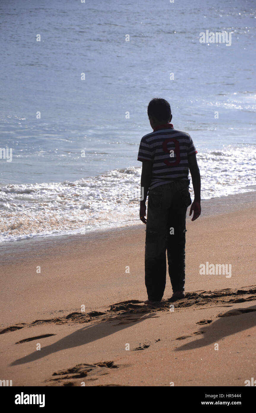 Boy standing on the sea side, Beach, Kerala India (Photo Copyright © by ...