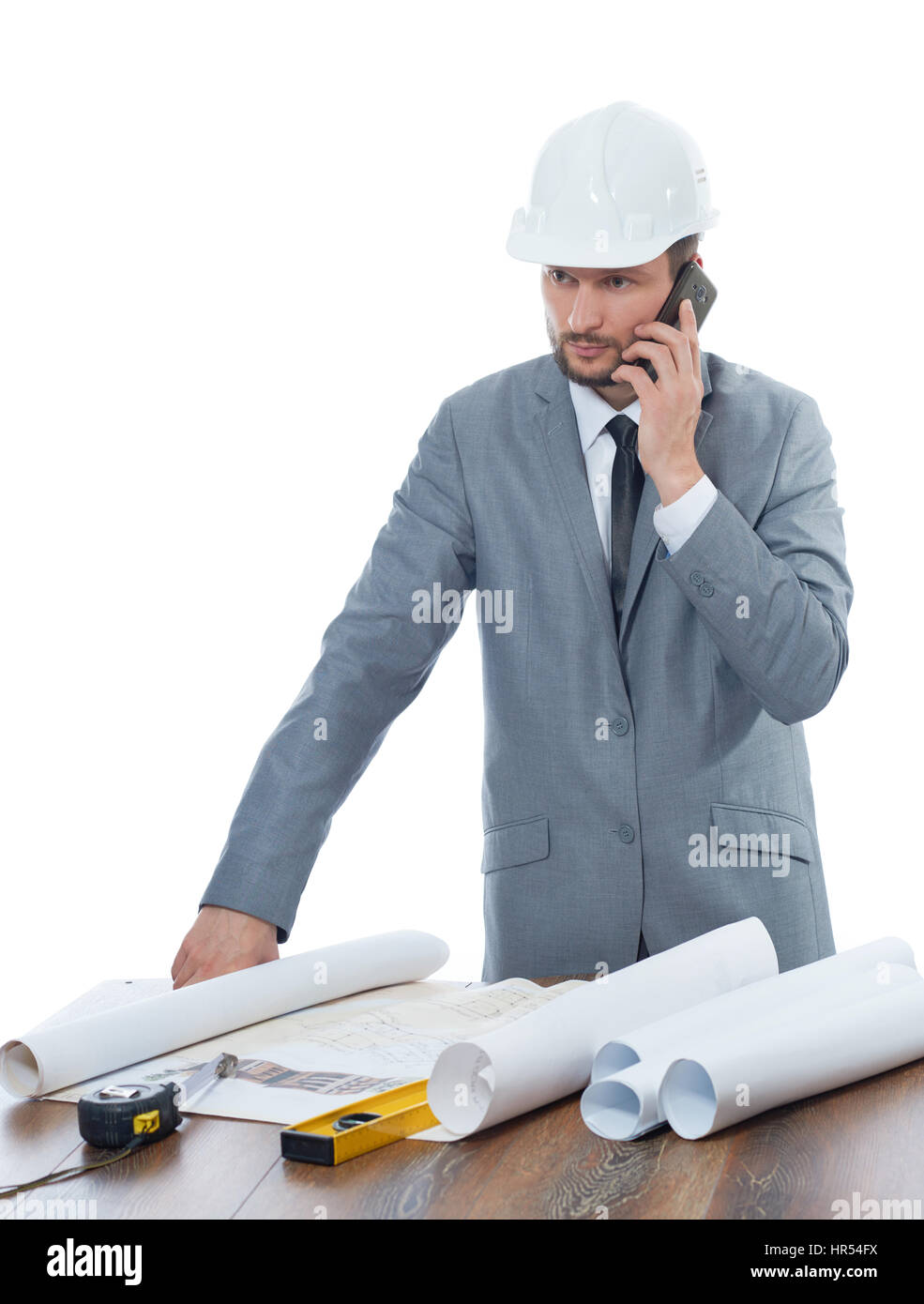 Important calls. Professional male engineer talking on his mobile phone ...