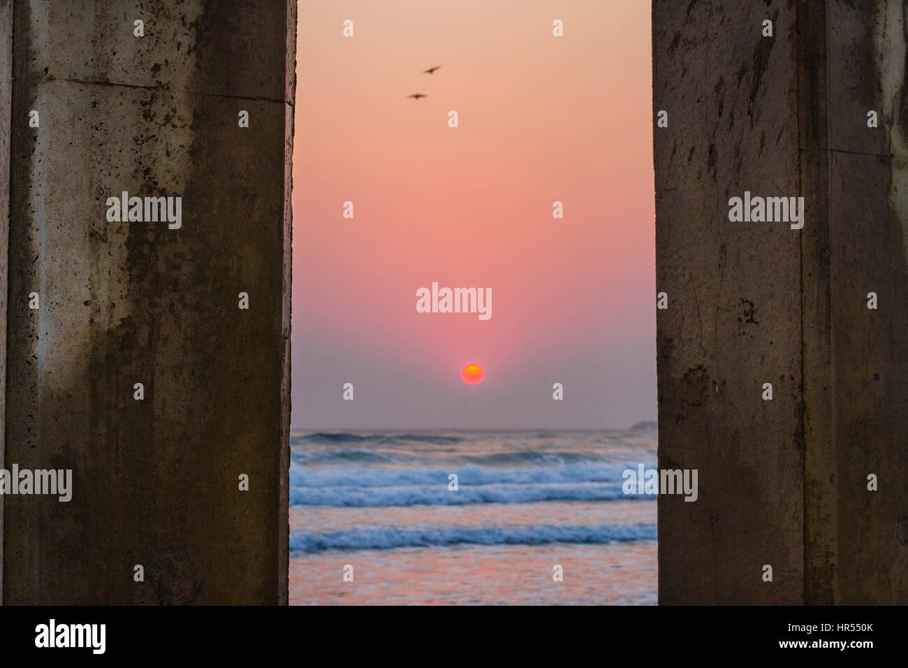 Red Sun Rising between Pillars Stock Photo - Alamy