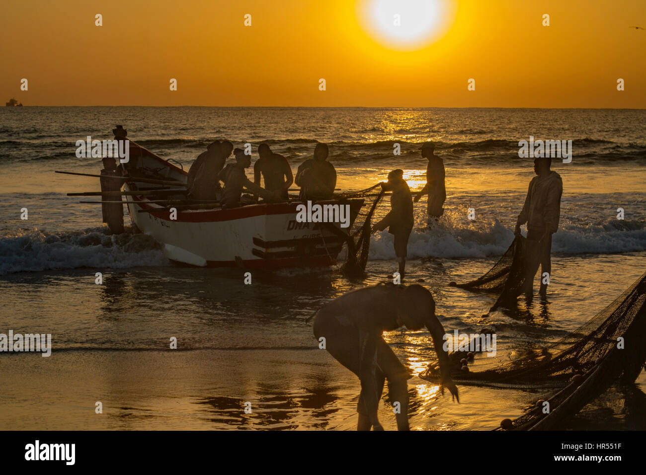 Fishermen preparing to launch small fishing boat Stock Photo - Alamy