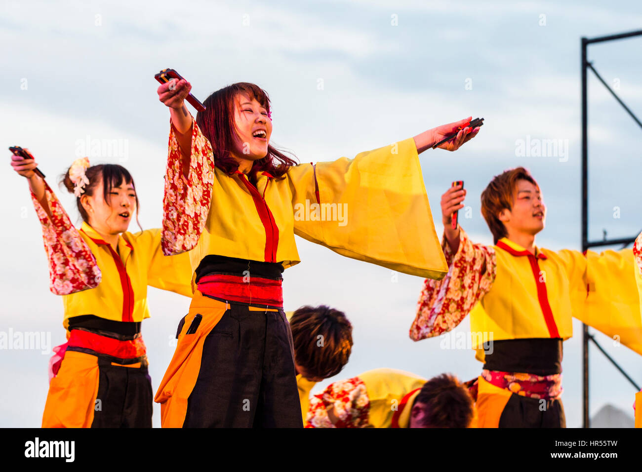 Yosakoi dance festival. Three dancers in yellow traditional yukata ...