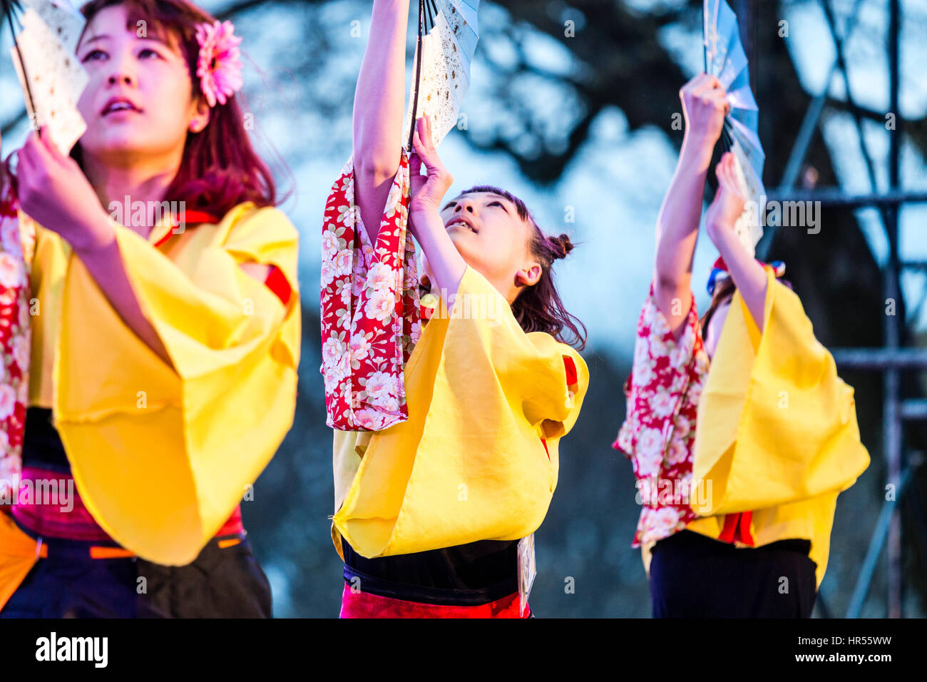 Yosakoi dance festival. Row of three woman dancers in yellow yukata ...