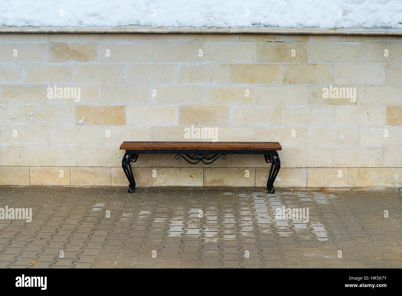 Bench standing against the wall Stock Photo - Alamy