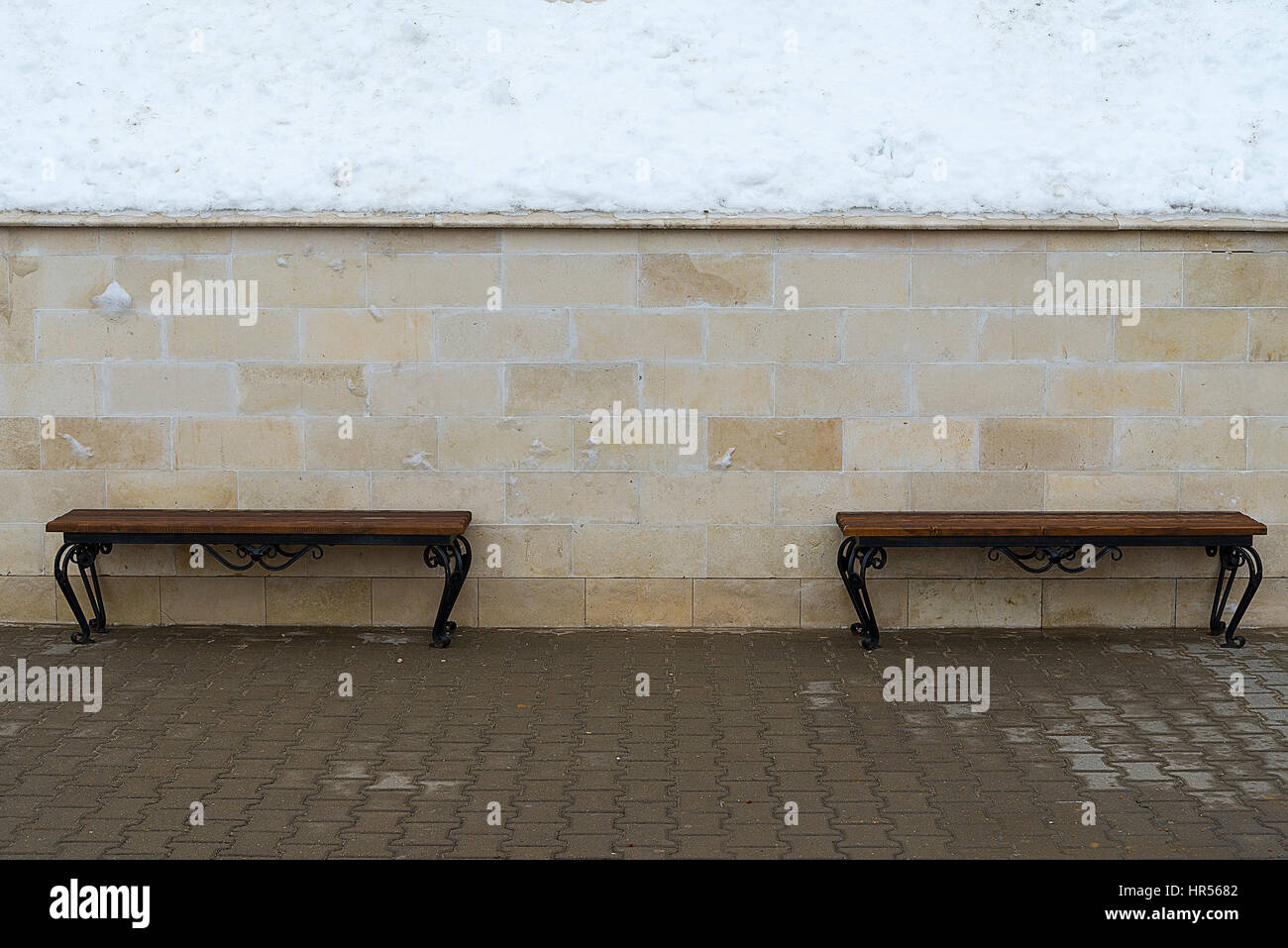 Benches standing against the wall Stock Photo - Alamy