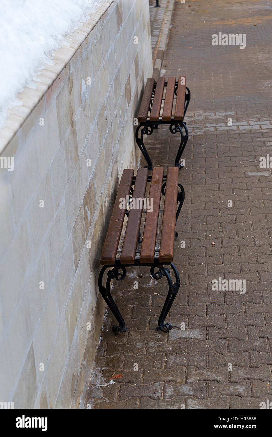 Benches standing against the wall Stock Photo - Alamy