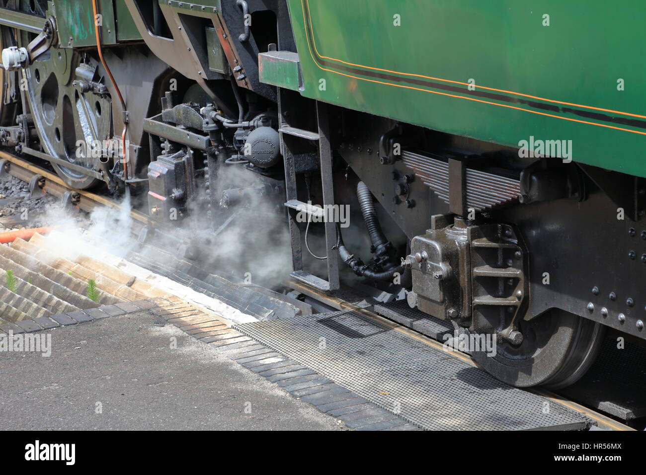 Tight crop of footplate, rolling wheels and steam of West Country class ...