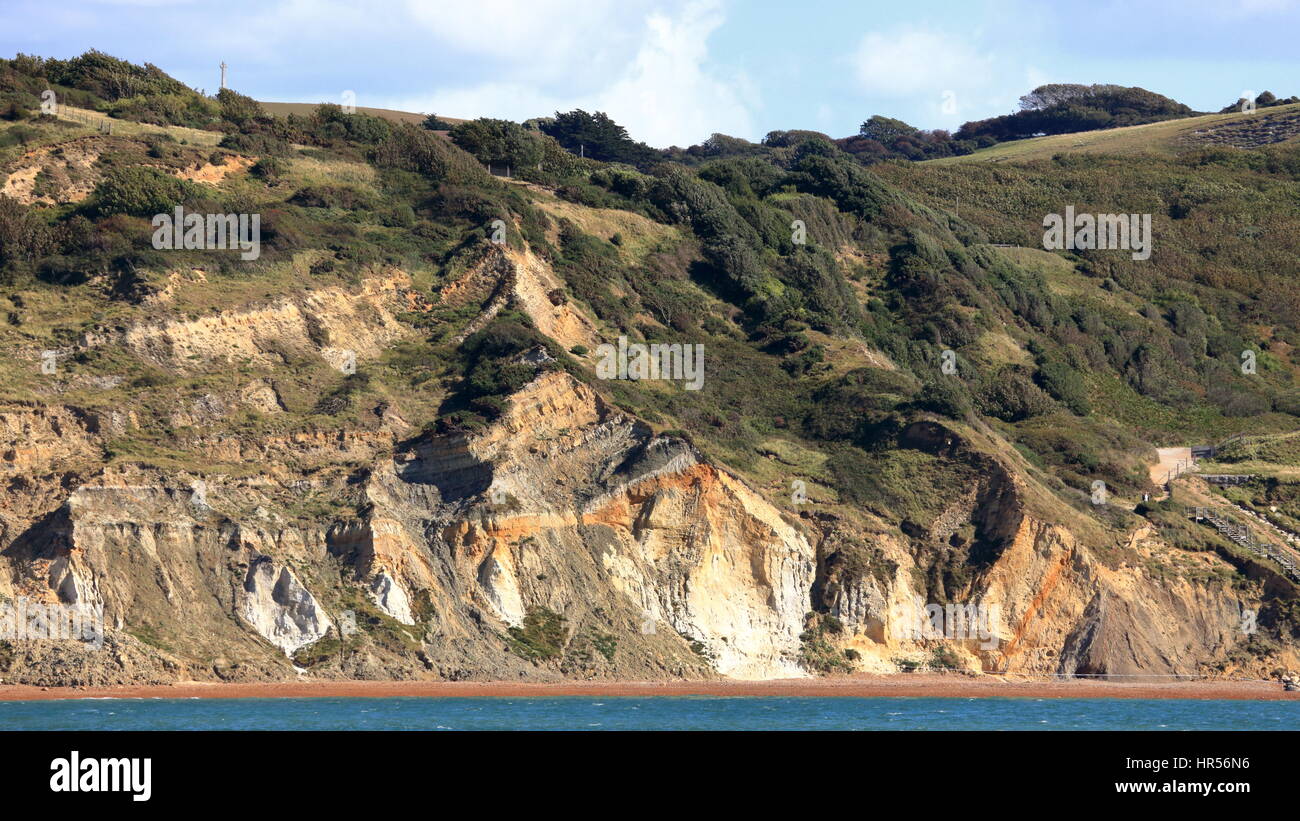 Richly colourful gnarled and weathered sandstone / limestone cliff face ...
